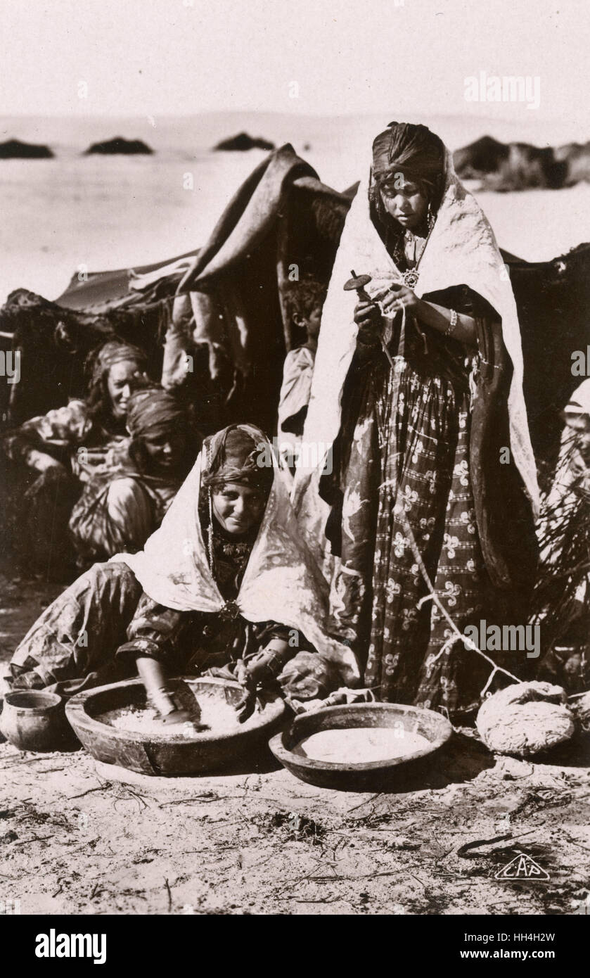 Algeria - Nomadic Women performing cooking and textile tasks Stock ...