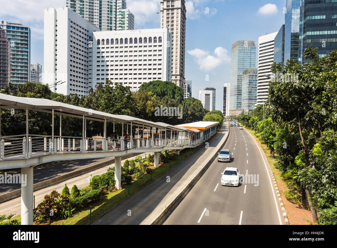 Light traffic on a sunny Sunday along the main avenue, Jalan Sudirman ...