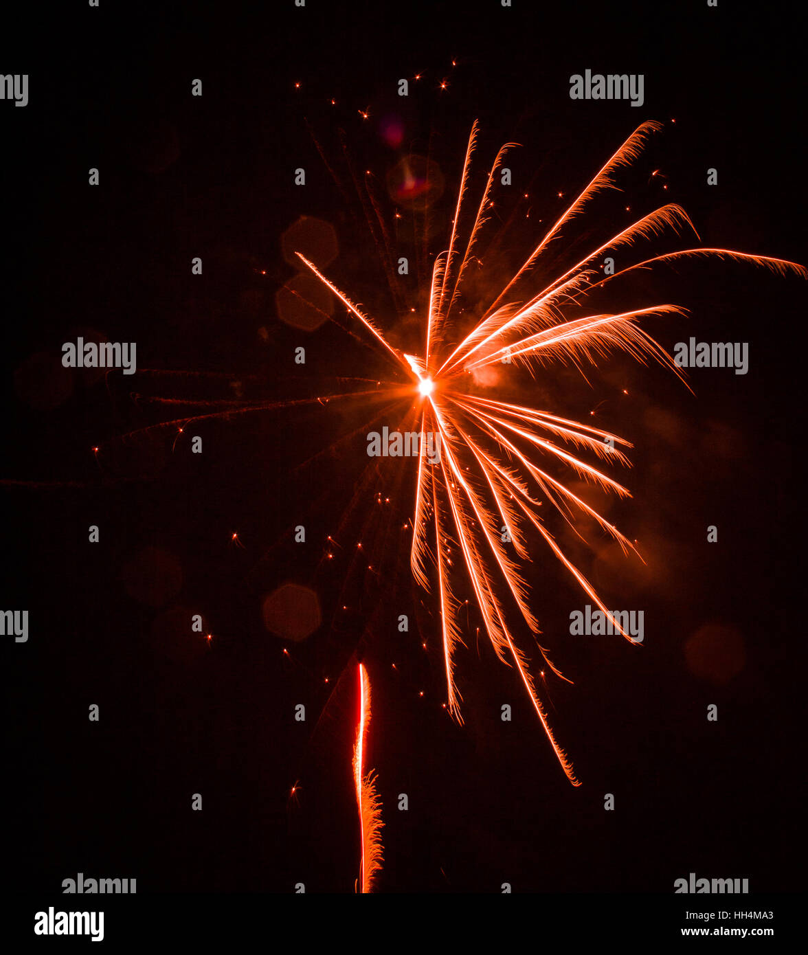 Beautiful orange firework on New Years eve Stock Photo - Alamy