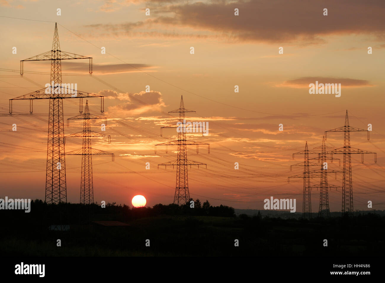 Pylons at sunset Stock Photo - Alamy