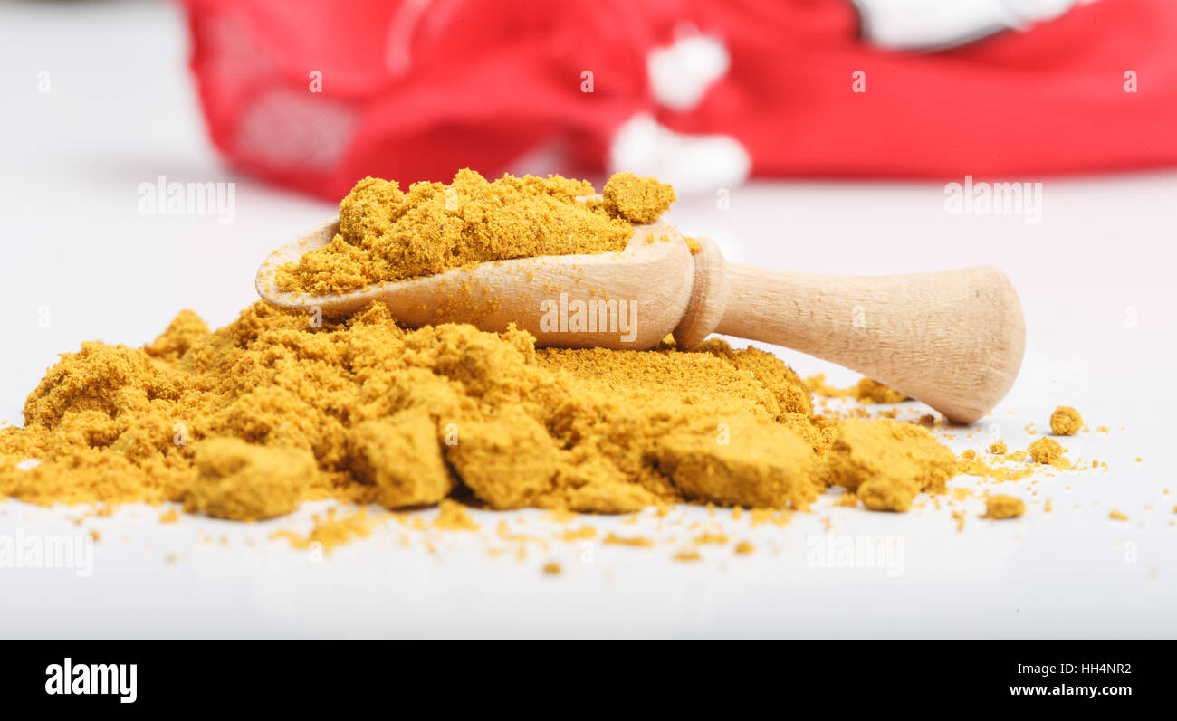 Aromatic yellow color curry powder ingredient on white table with ...