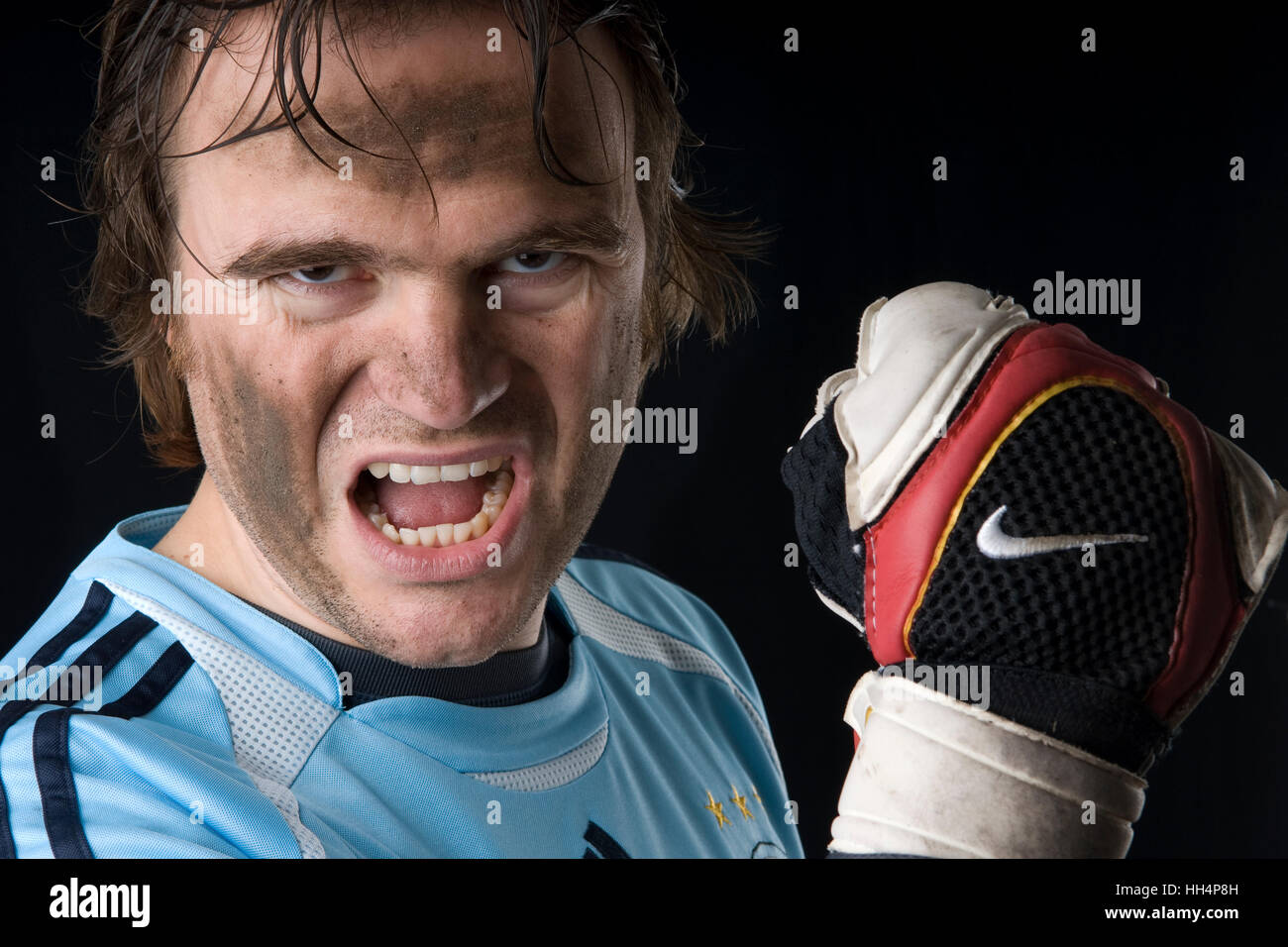 Screaming sportsman (goalkeeper) with emotional face Stock Photo - Alamy
