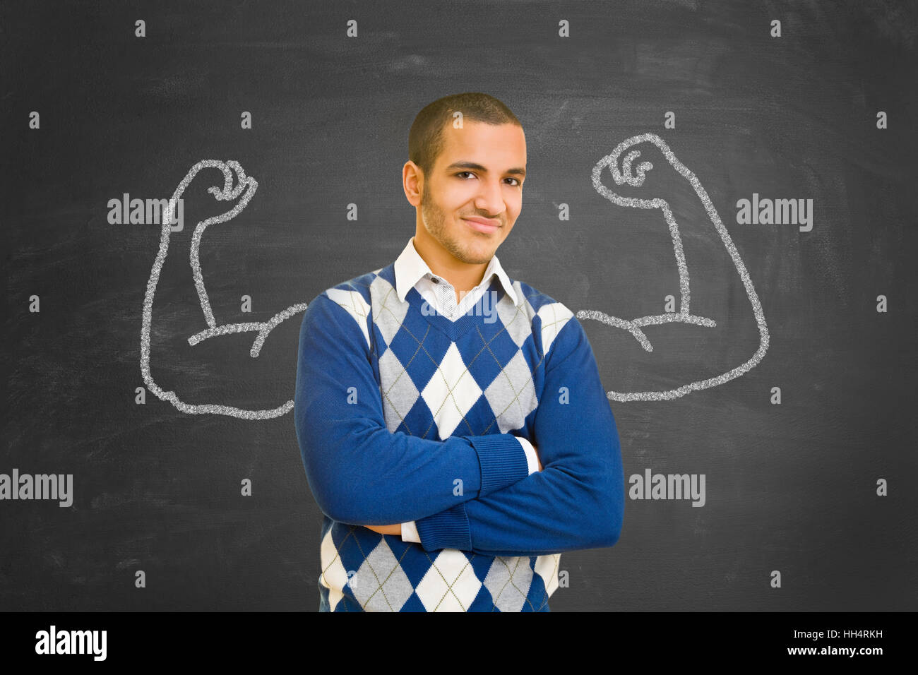 Successful and powerful student with muscles of chalk on blackboard as ...