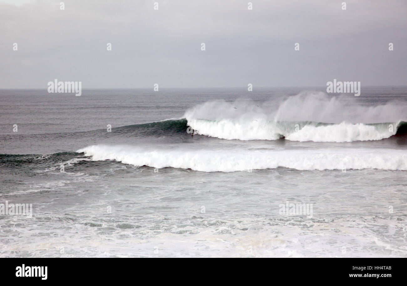 Surfers ride the Cribbar wave reaching heights of 25ft in Newquay ...