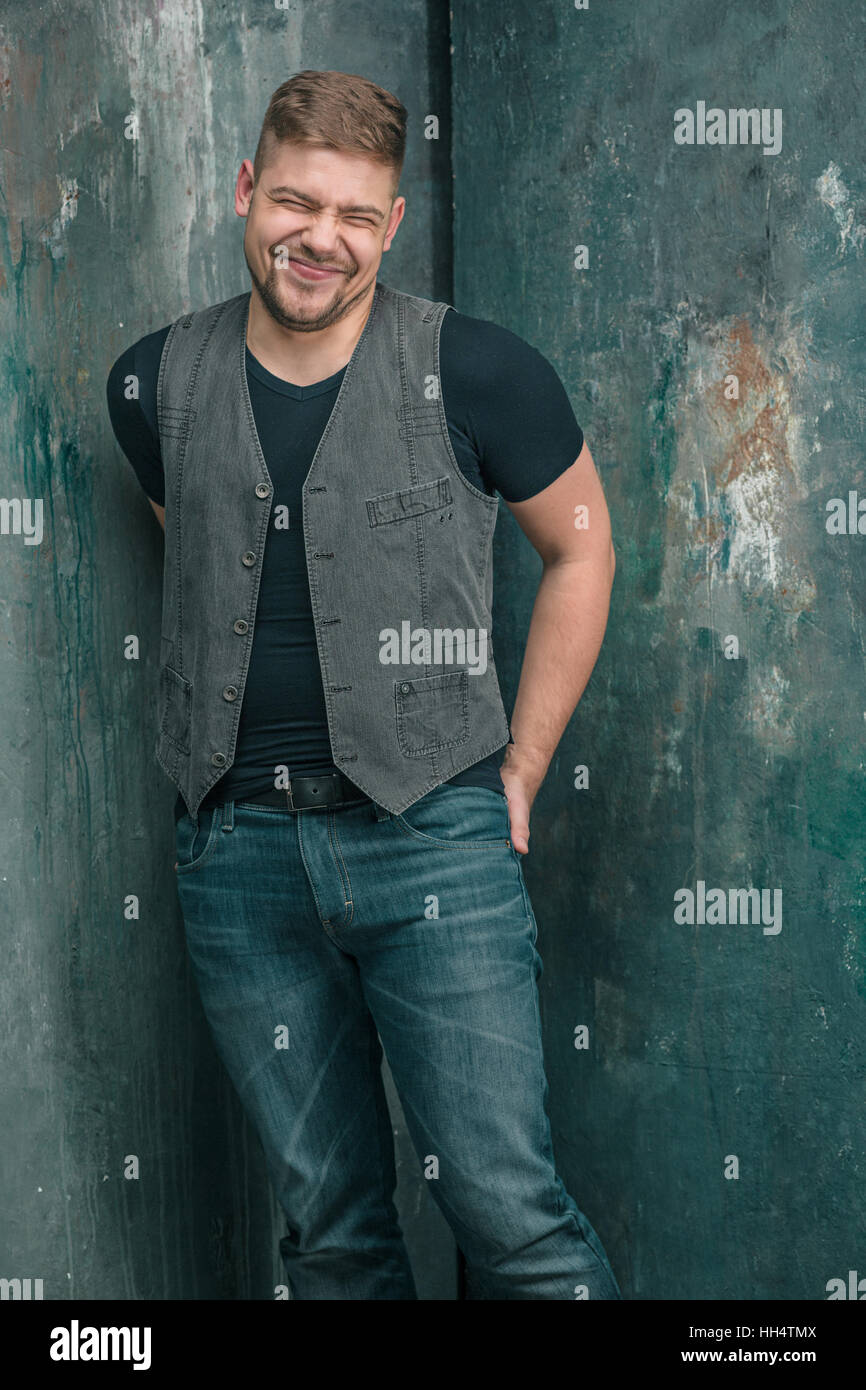 Portrait of smiling happy man standing on gray studio background Stock ...