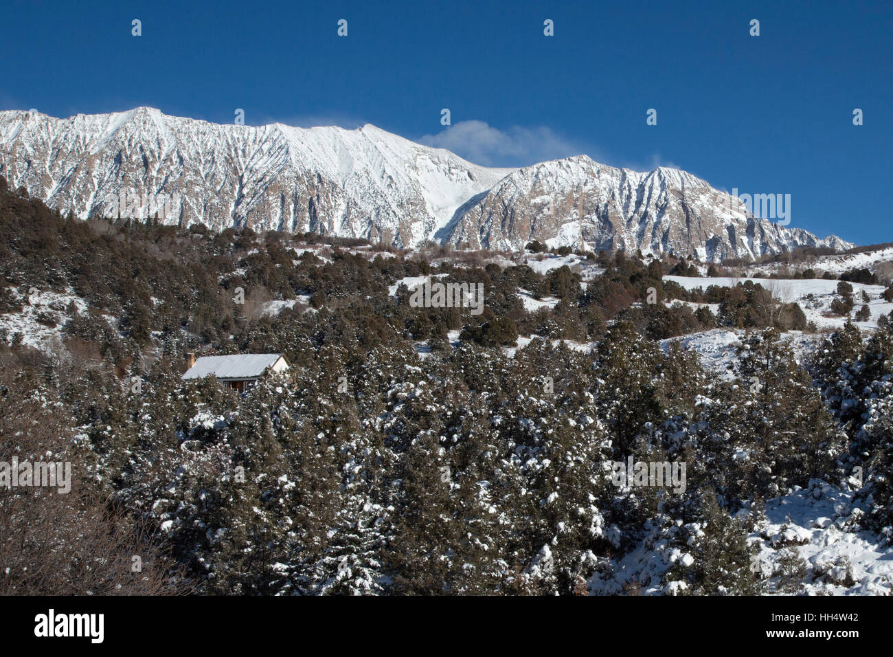Gunnison County, Colorado - An isolated home below the snow-capped Elk ...