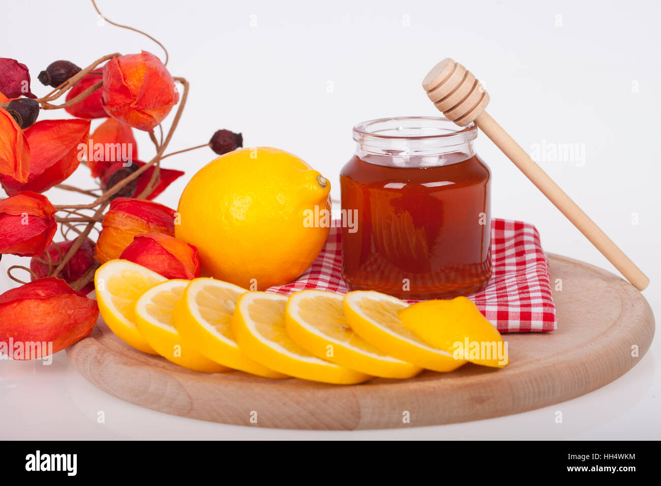 Honey in jar with honey dipper on a wooden background Stock Photo - Alamy