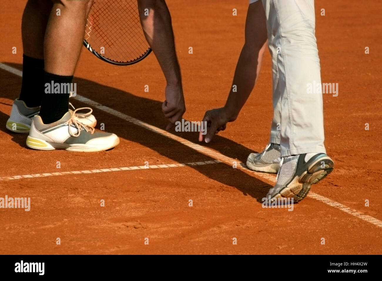 Tennis line referee and tennis player after serve Stock Photo - Alamy