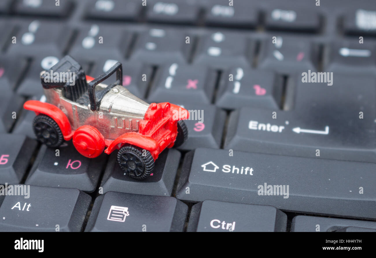 Toy car over laptop keyboard, background,texture online Stock Photo - Alamy