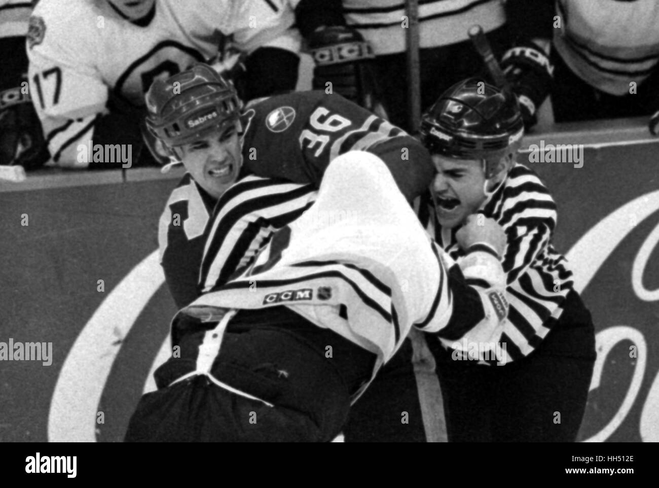 NHL linesman Bernard Grace gets between Boston Bruins Brent Hughes and ...