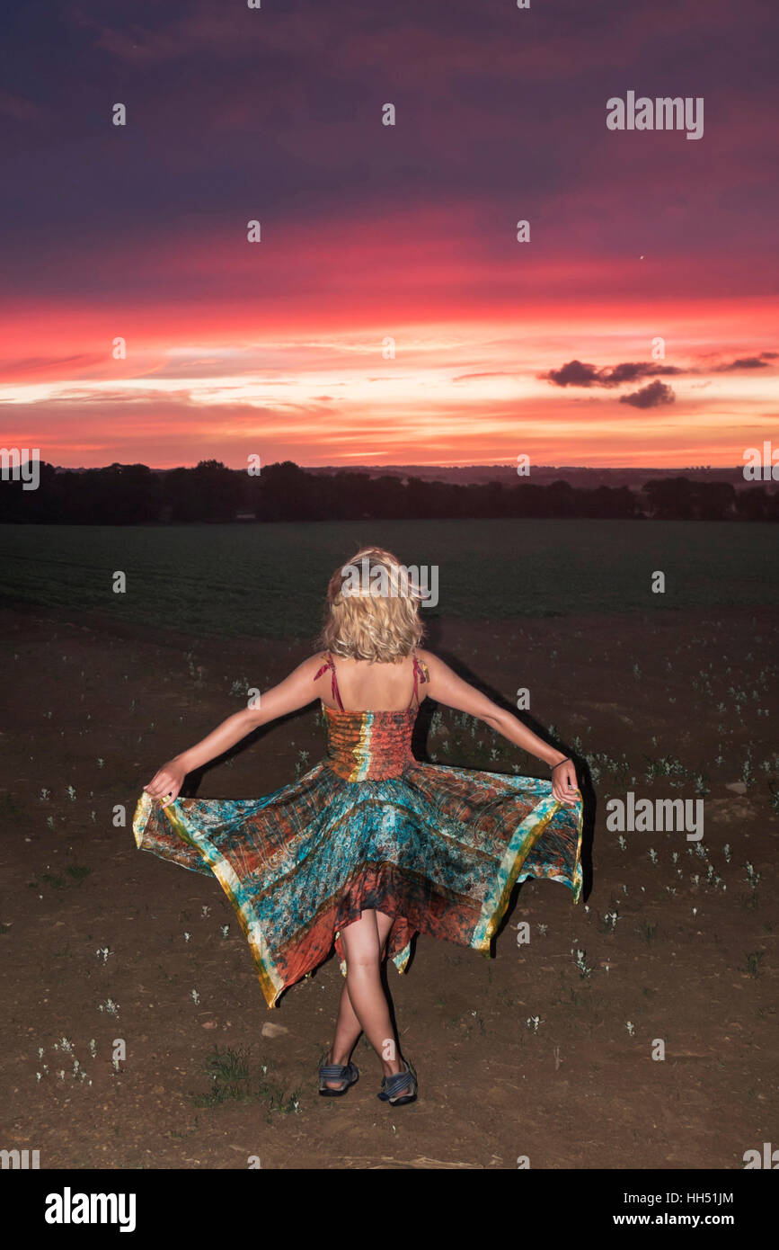 girl arms akimbo sunset Stock Photo - Alamy