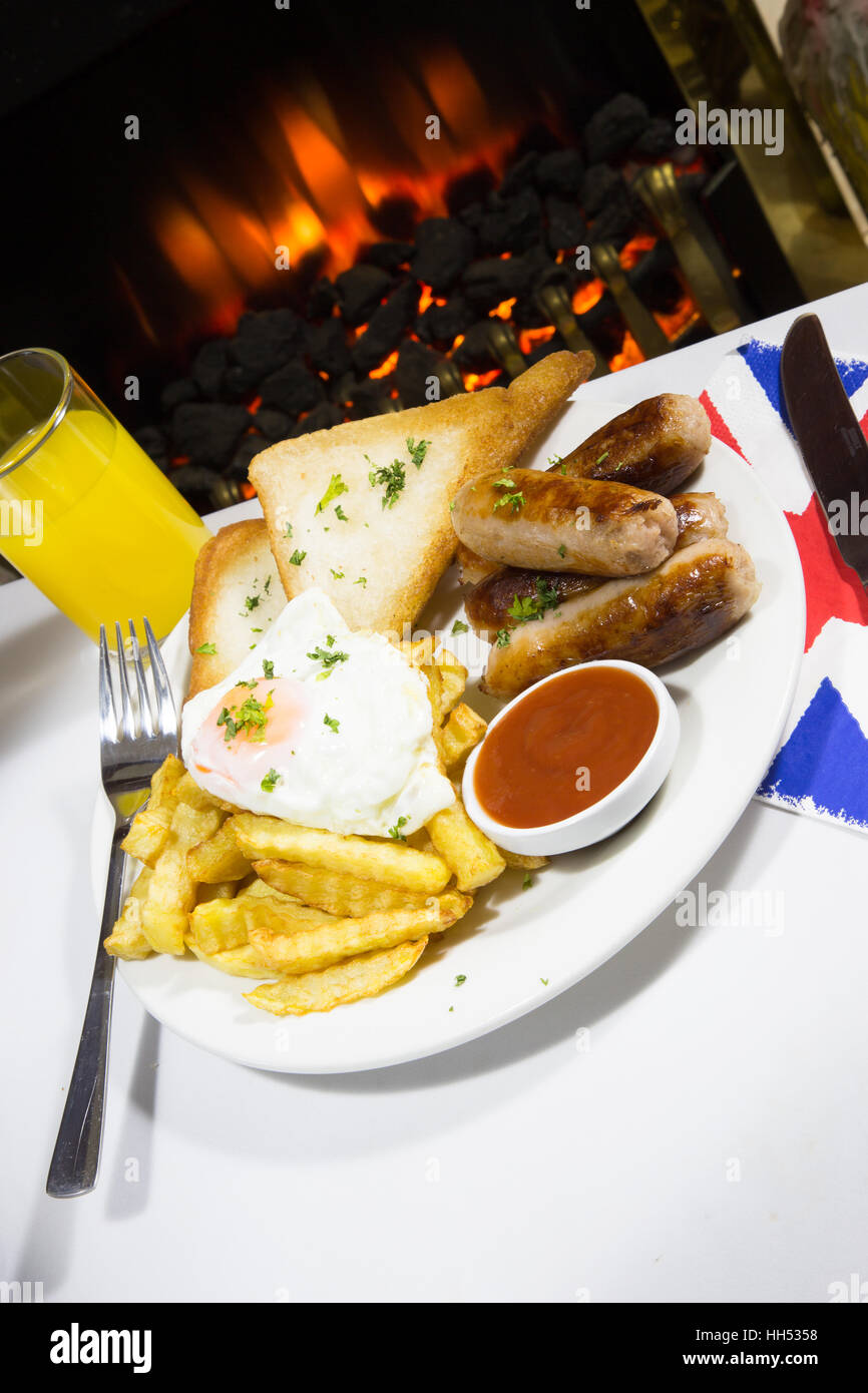 English pub dinner of Sausage, fried egg and chips/fries Stock Photo ...