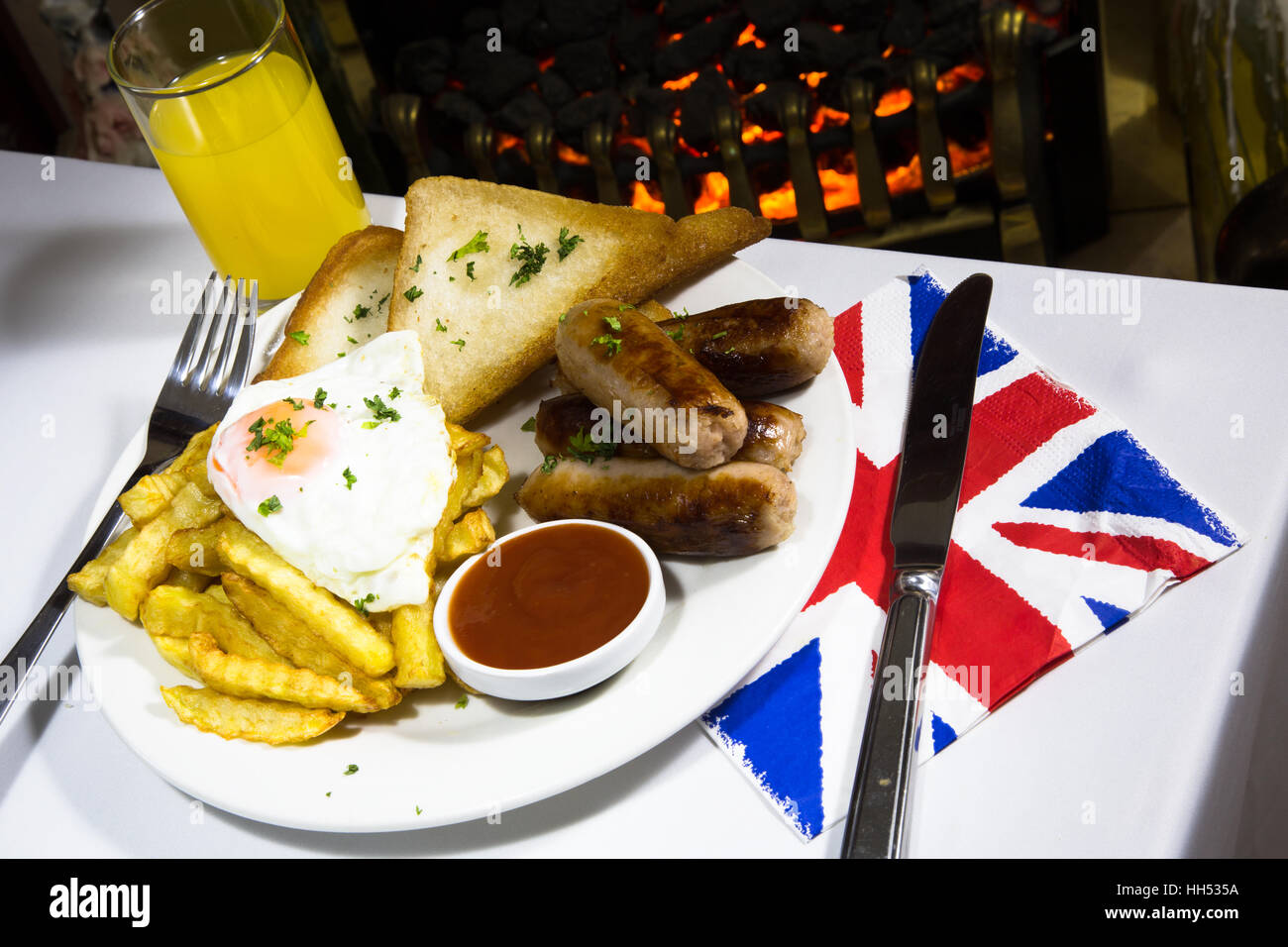 English pub dinner of Sausage, fried egg and chips/fries Stock Photo ...
