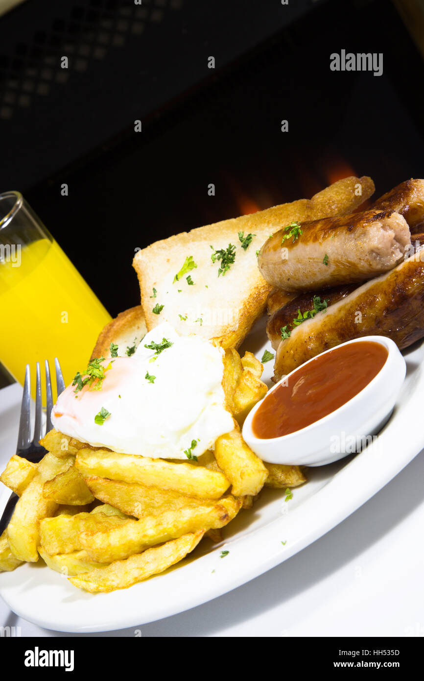 English pub dinner of Sausage, fried egg and chips/fries Stock Photo ...