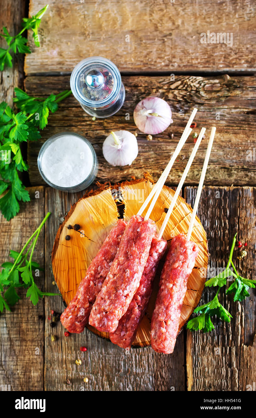 raw kebab on board and on a table Stock Photo - Alamy