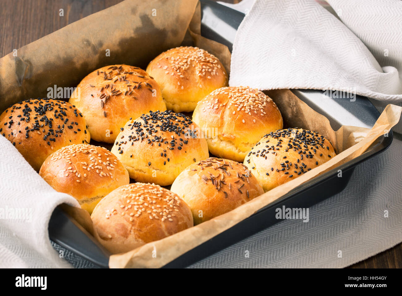 Homemade tasty buns with sesame and cumin on tray Stock Photo - Alamy