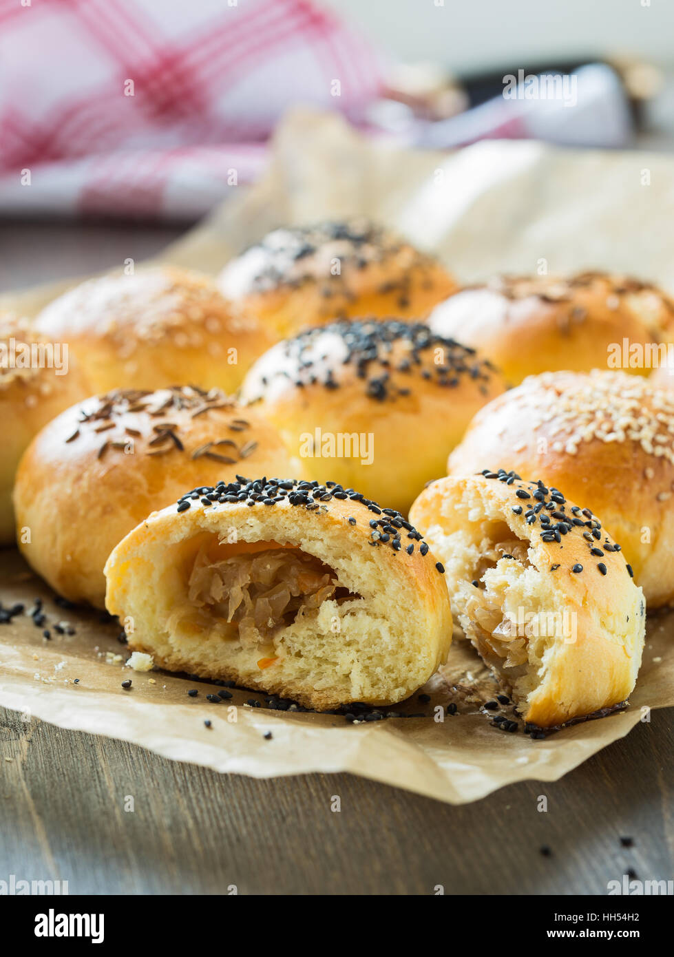 Homemade tasty cabbage buns with sesame and cumin on baking paper Stock ...