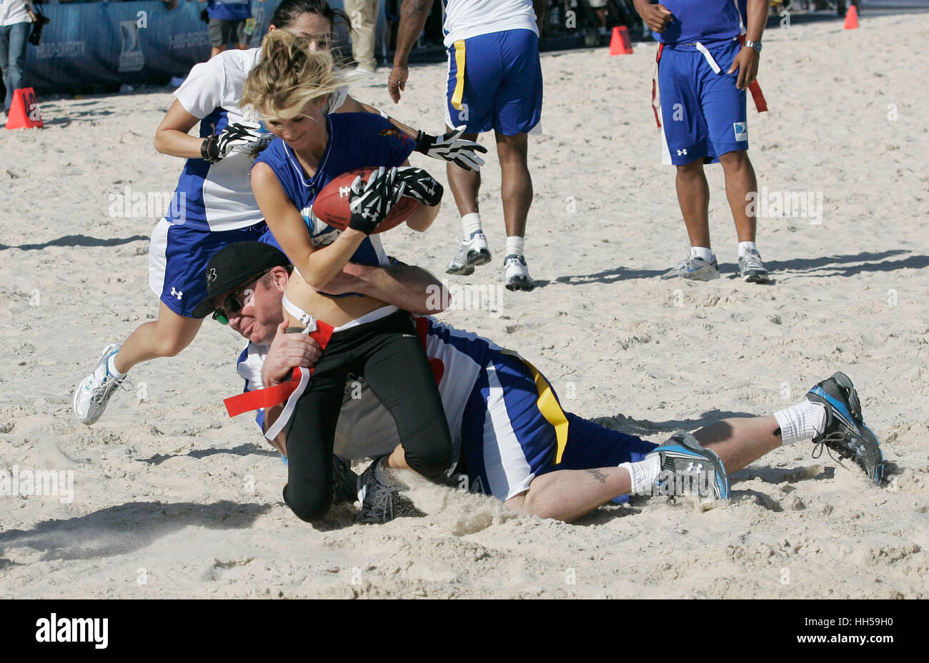 Marisa Miller gets tackled by Tom Arnold at the Directv Celebrity Beach ...