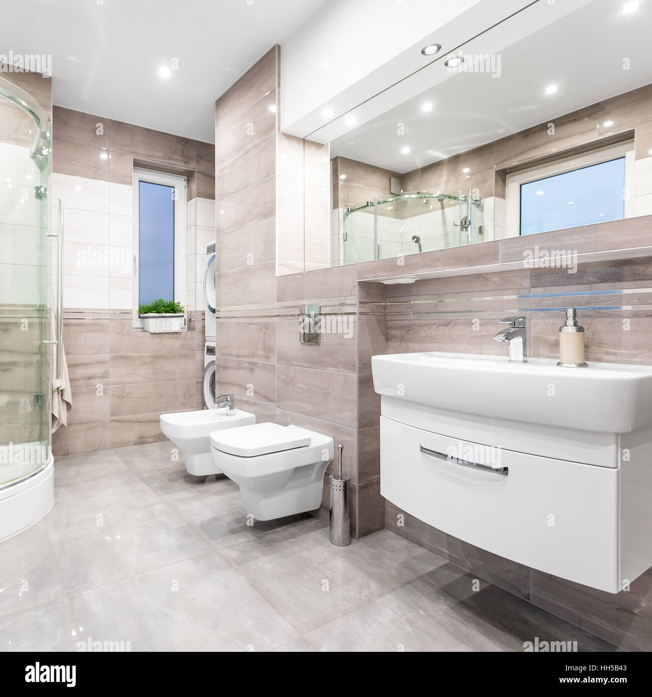 Functional beige bathroom with window, shower, toilet, bidet, basin and ...