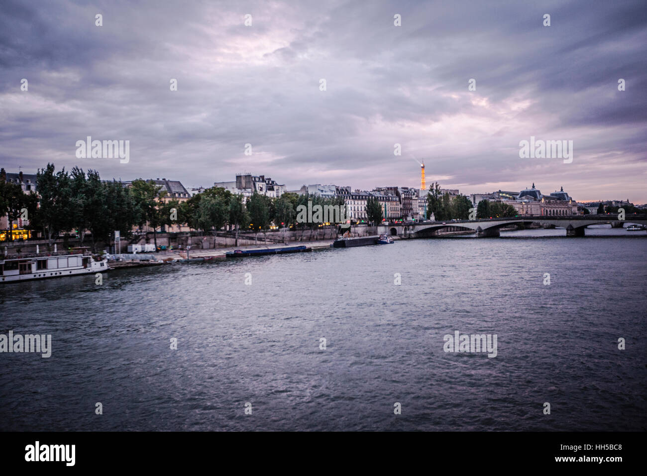 The River Seine with the Eiffel tower at sunset in Paris Stock Photo ...