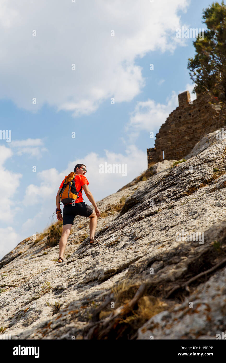 Boy with backpack on mountain Stock Photo - Alamy