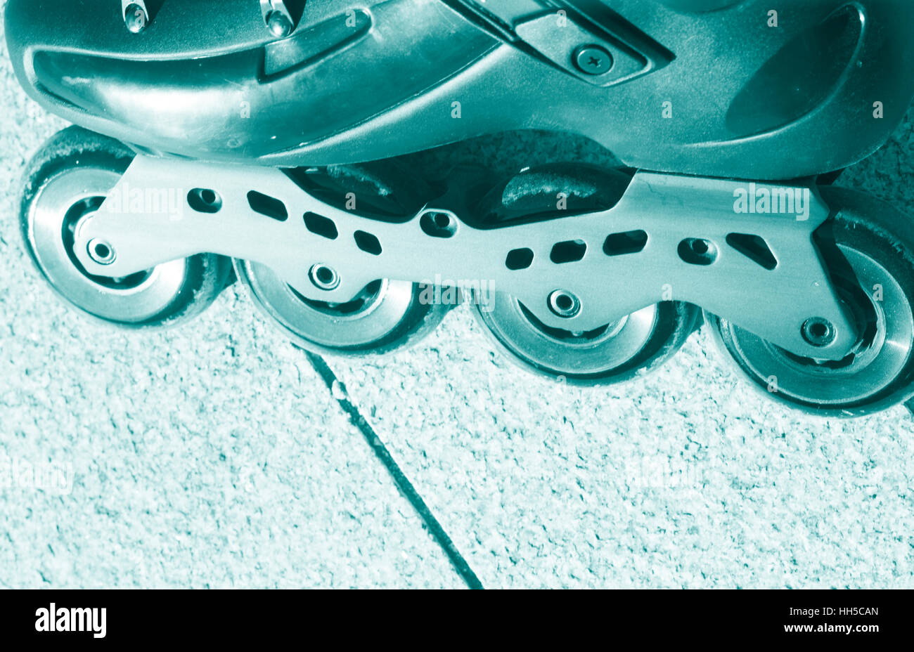 Inline freestyle roller blade skates in street on road surface skating ...