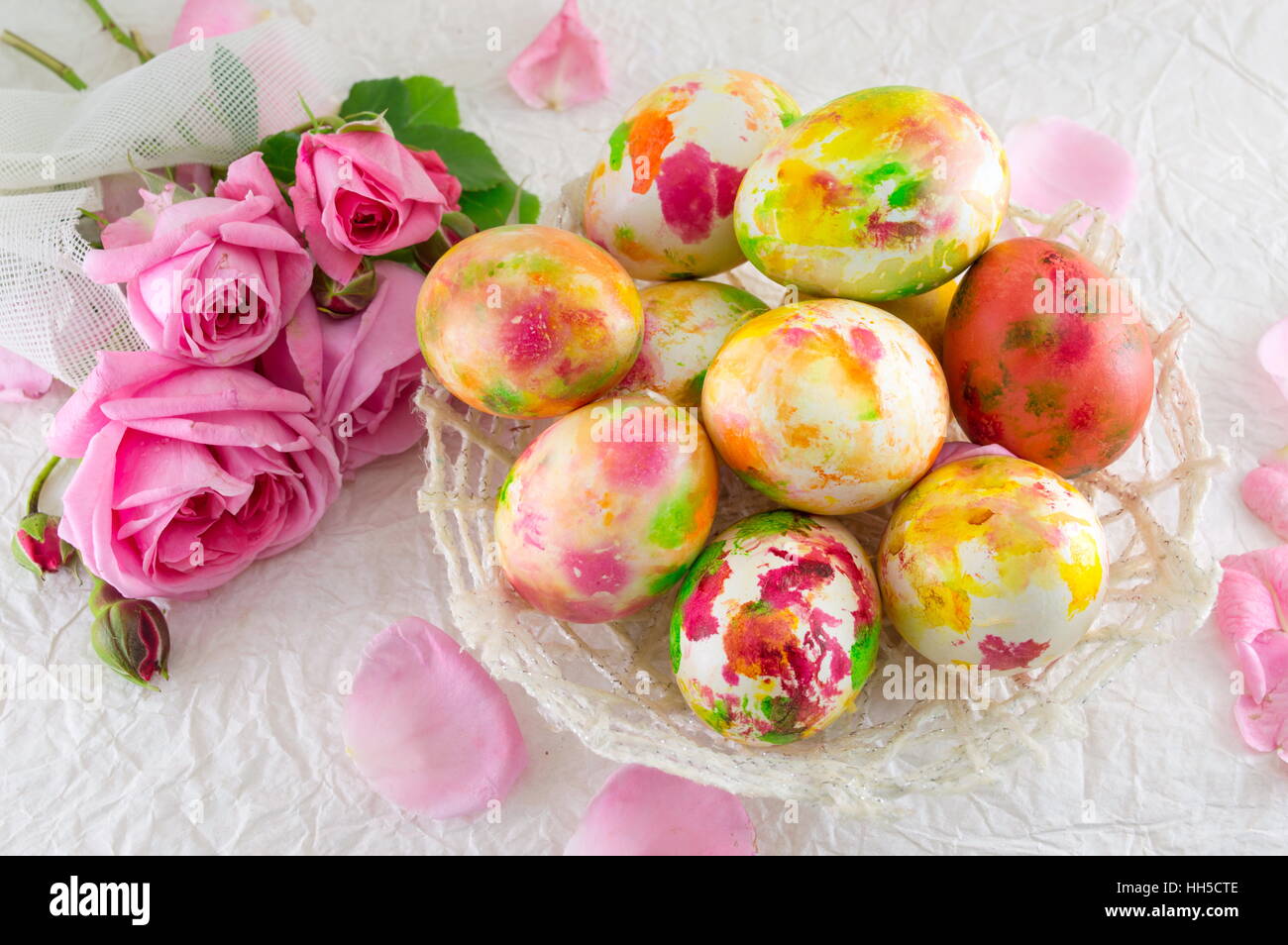 Easter eggs in a bowl and pink roses bouquet Stock Photo - Alamy
