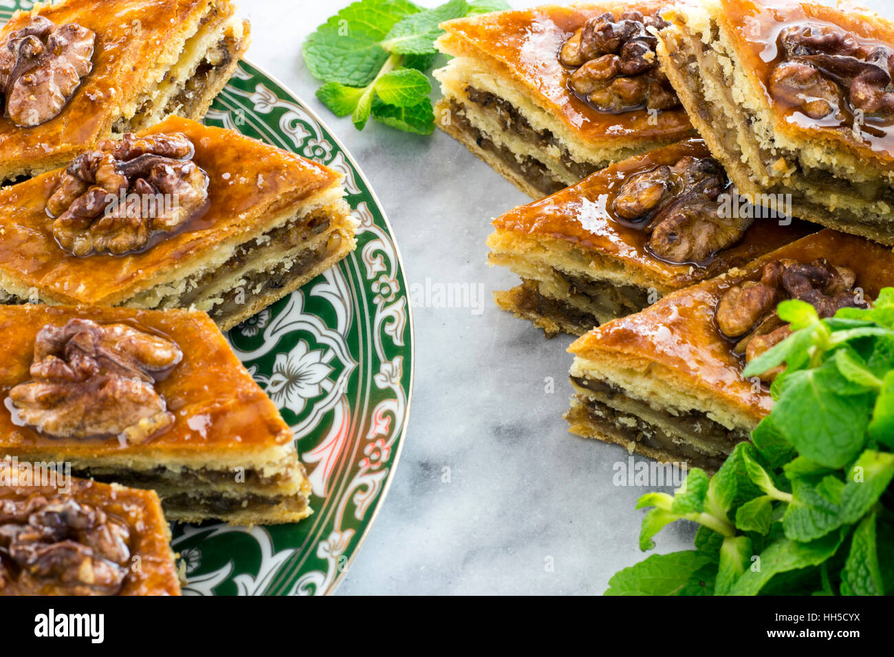 Honey baklava on the saucer with oriental design Stock Photo - Alamy