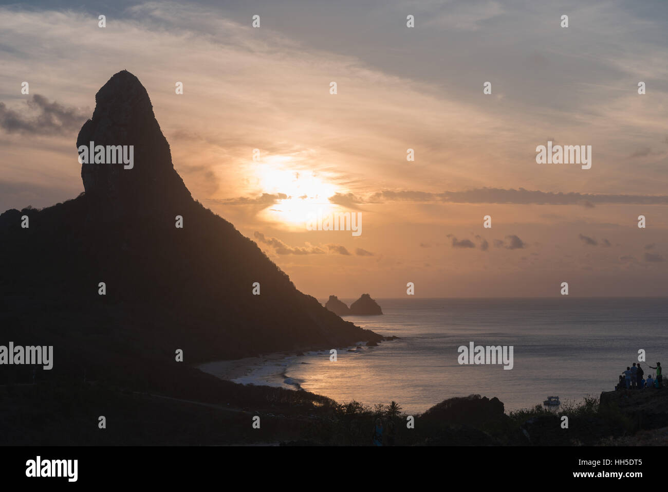 Spectacular sunset behind the rock "Morro do Pico", island "Fernando de ...