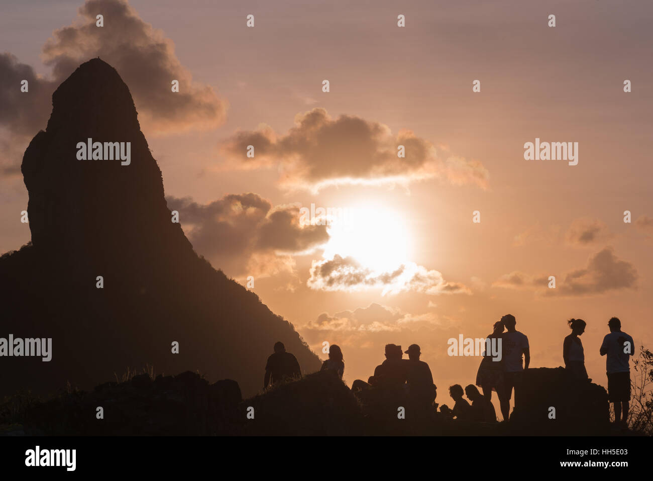 Watching the sunset behind the rock "Morro do Pico", island "Fernando ...