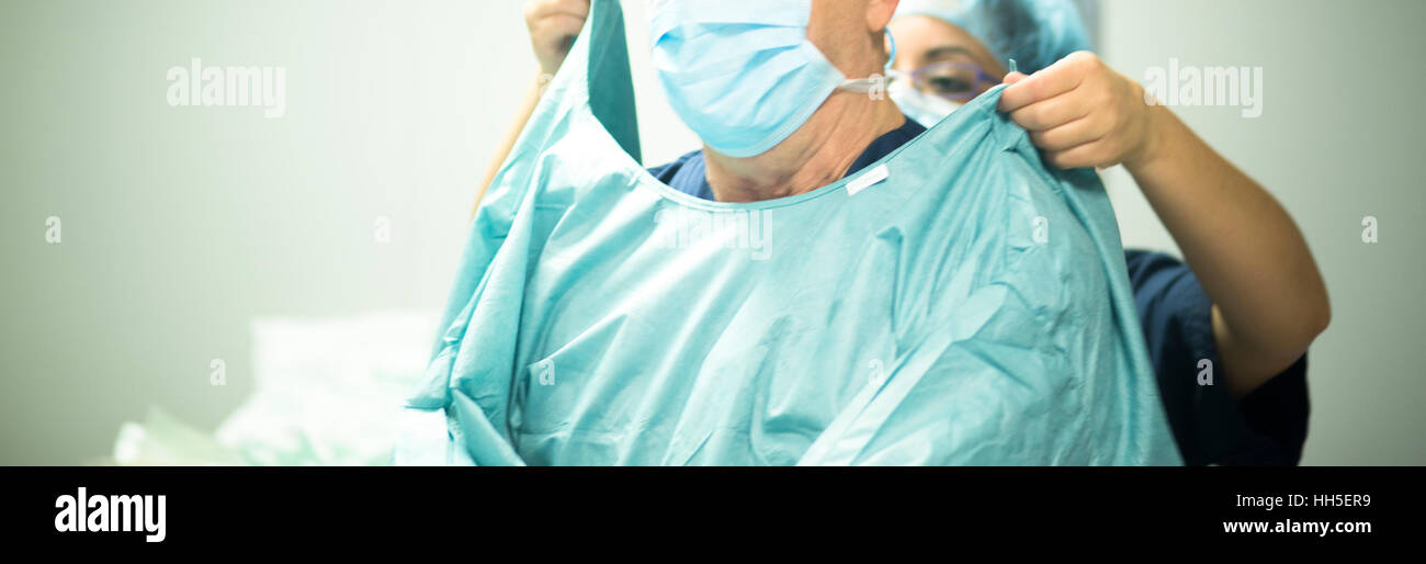 Surgeon in hospital surgery in sterile uniform "scrubs" and mask in ...