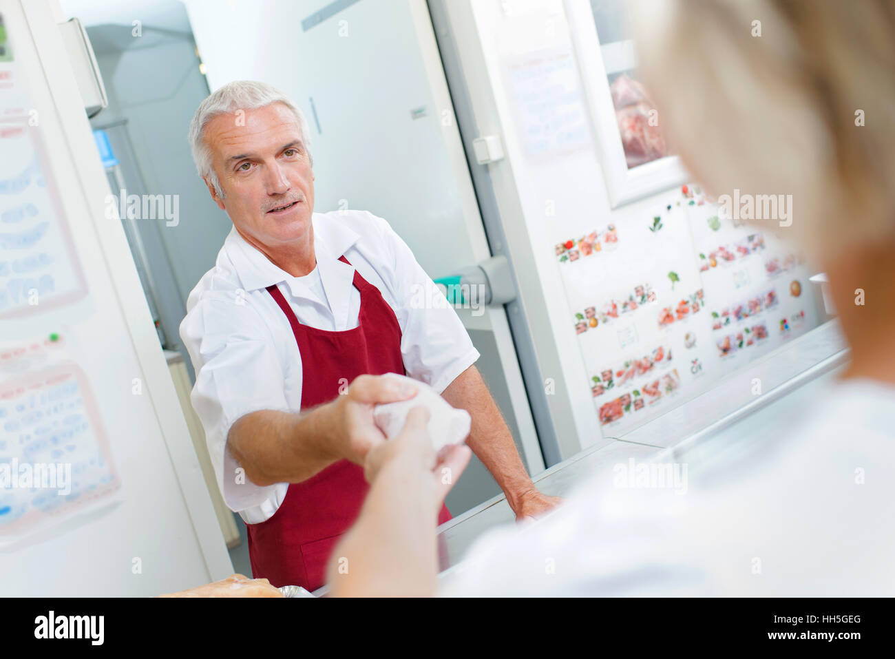 butcher handing meat Stock Photo - Alamy