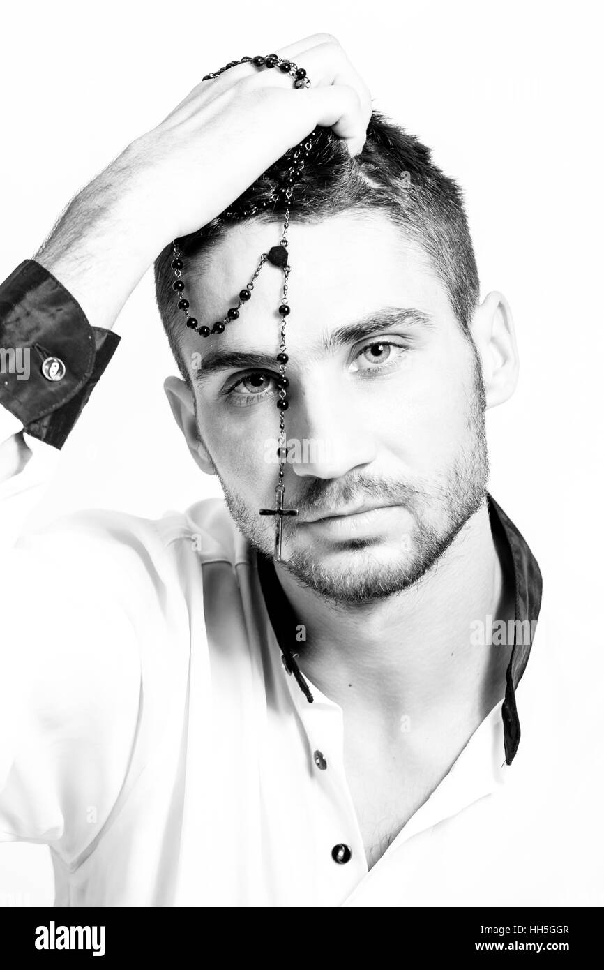 Man with rosary with a cross holding his head. The beauty of ...