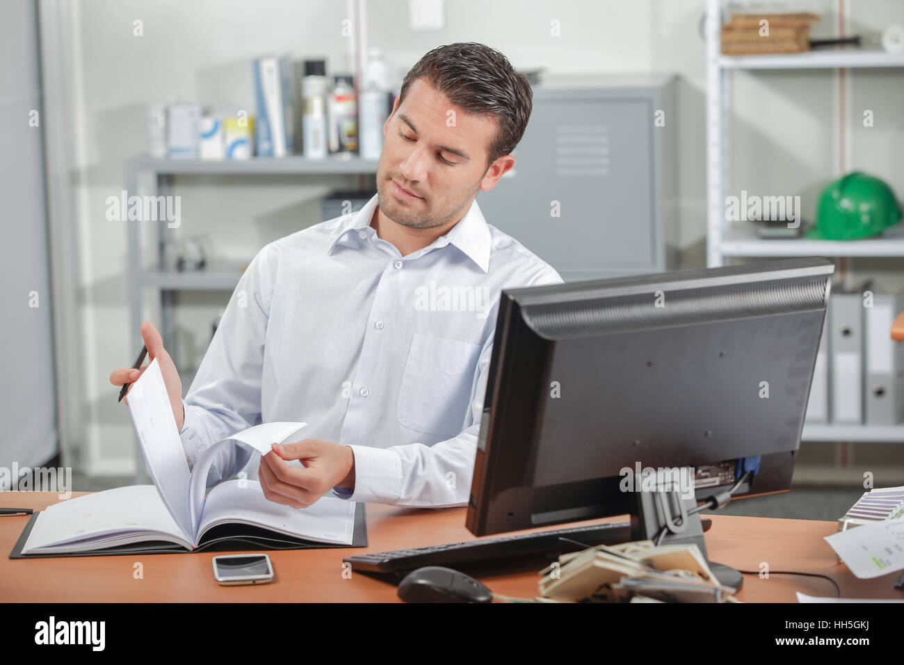 Office worker reading at his desk Stock Photo - Alamy
