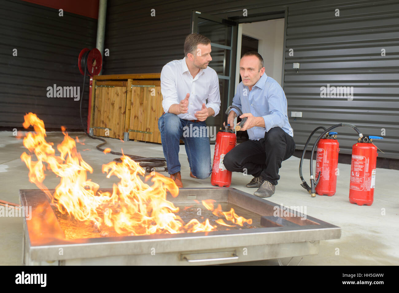 Men training with fire extinguishers Stock Photo - Alamy