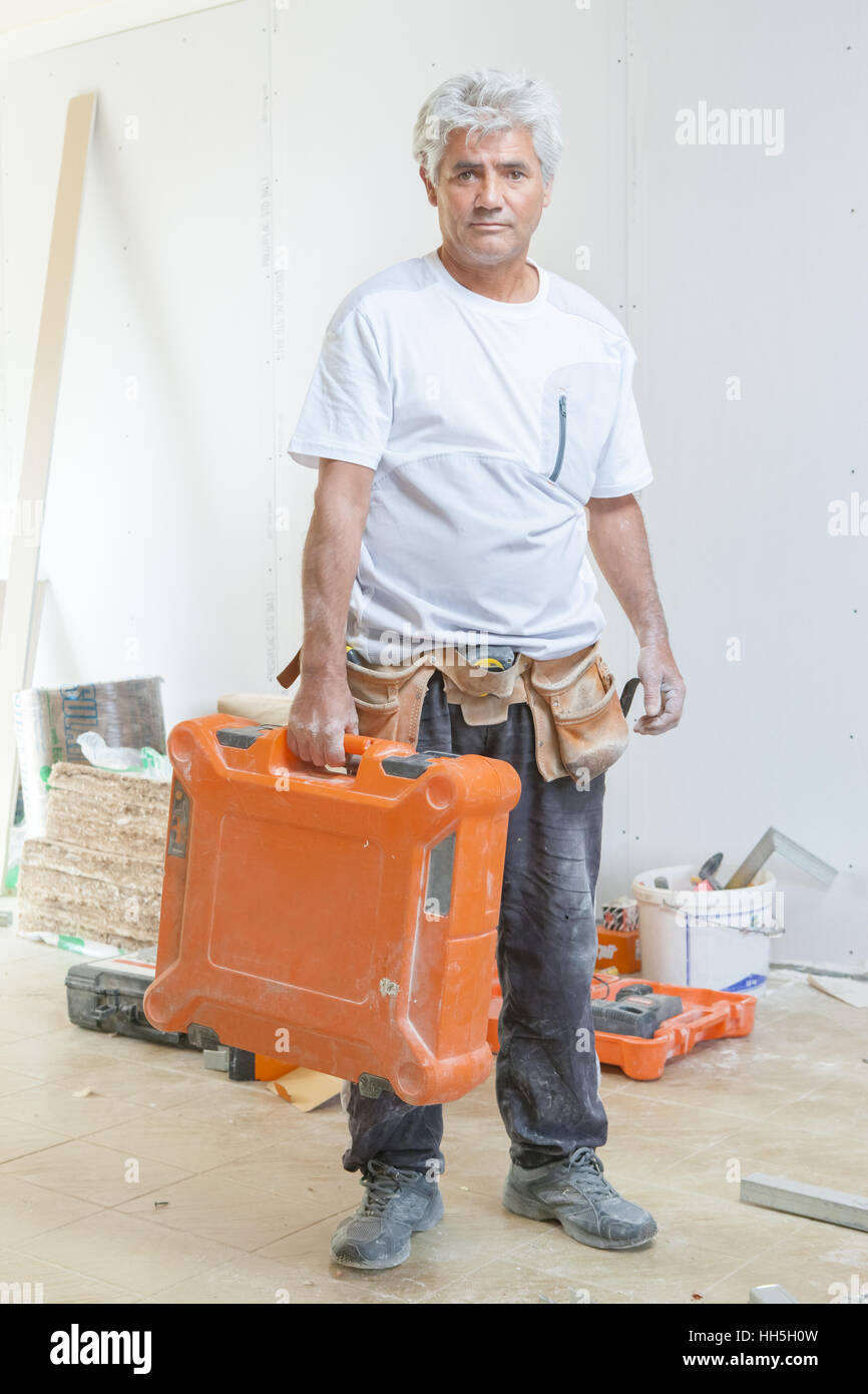 Mason holding his toolbox Stock Photo - Alamy