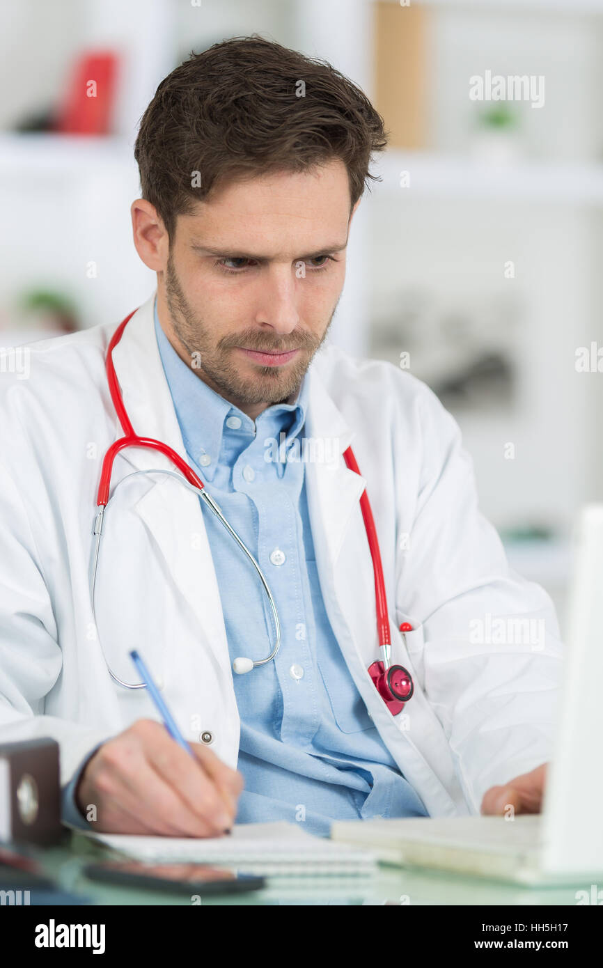 handsome young doctor at work in his office Stock Photo - Alamy