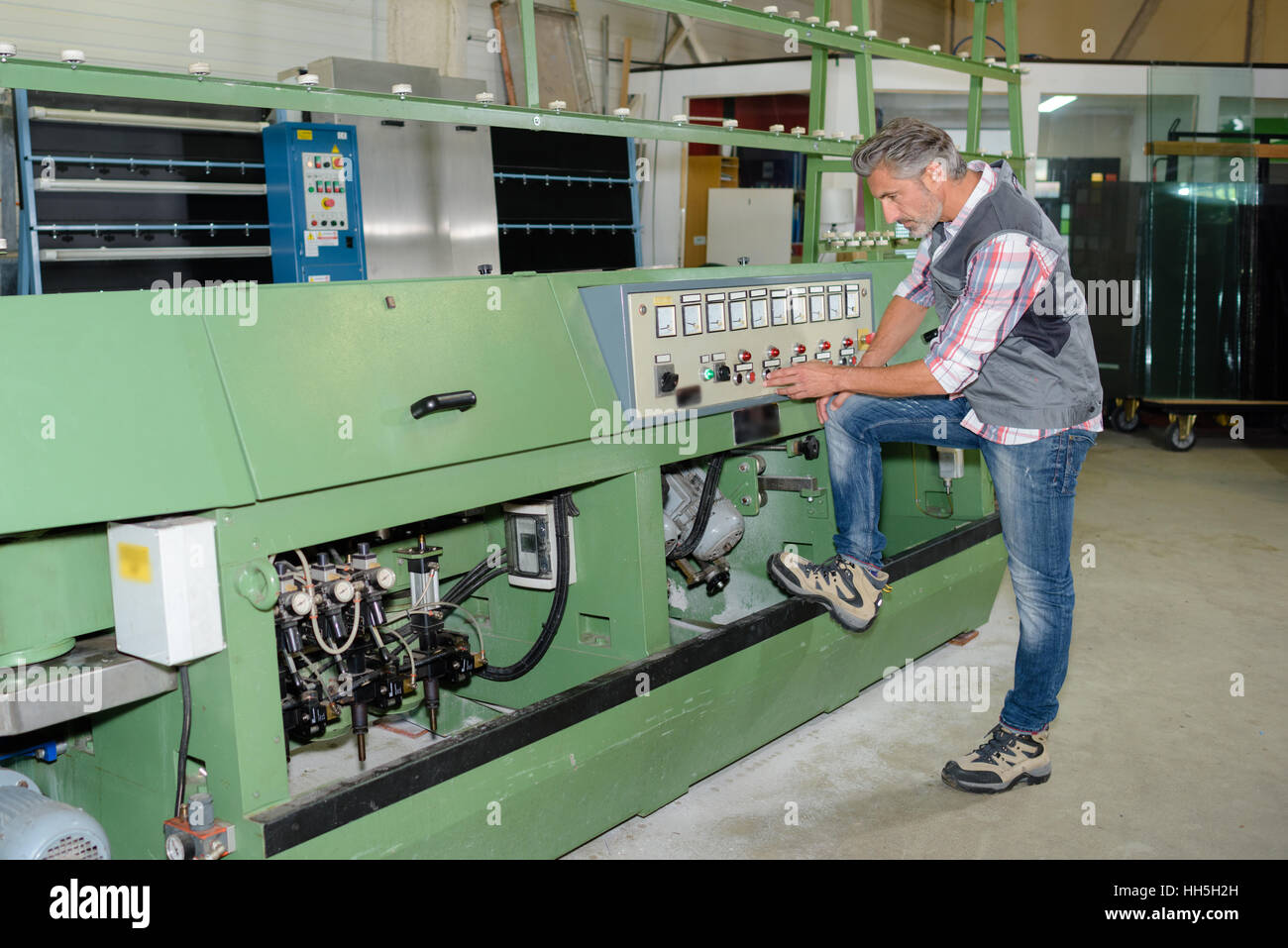 Man setting up factory machinery Stock Photo - Alamy