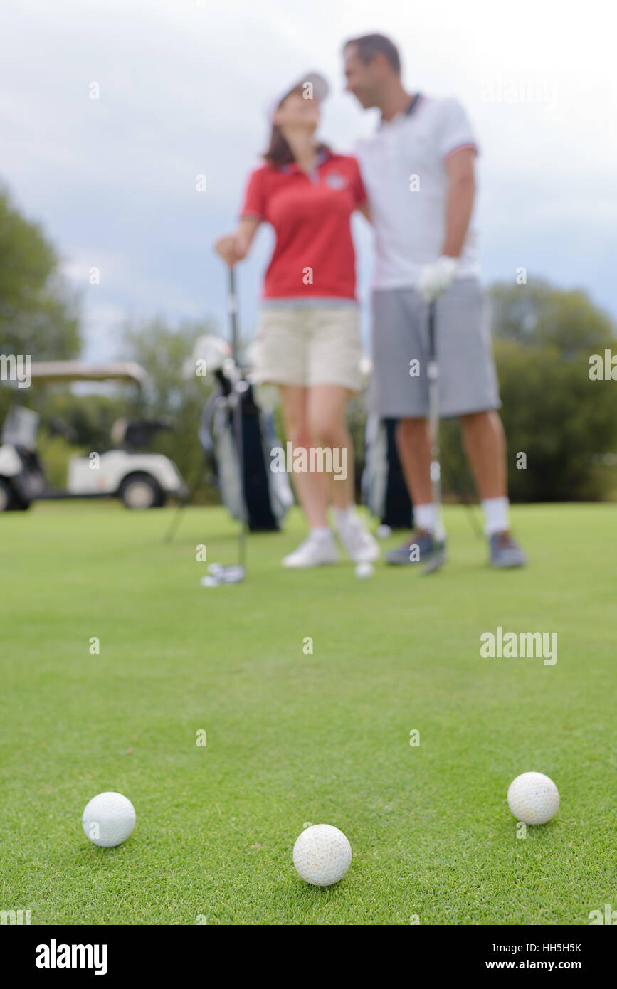 couple standing on golf course Stock Photo - Alamy