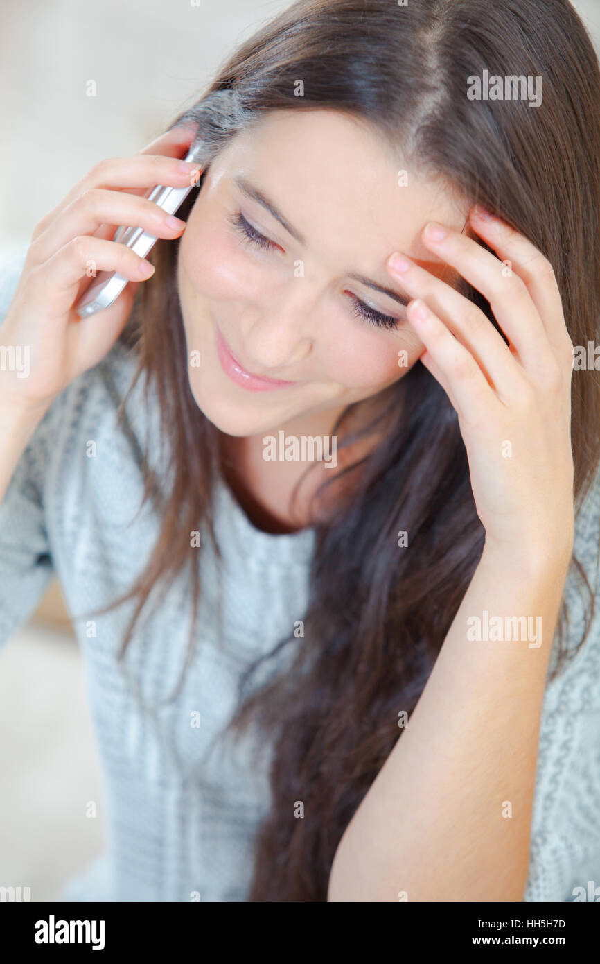 Woman looks worried during phone call Stock Photo - Alamy