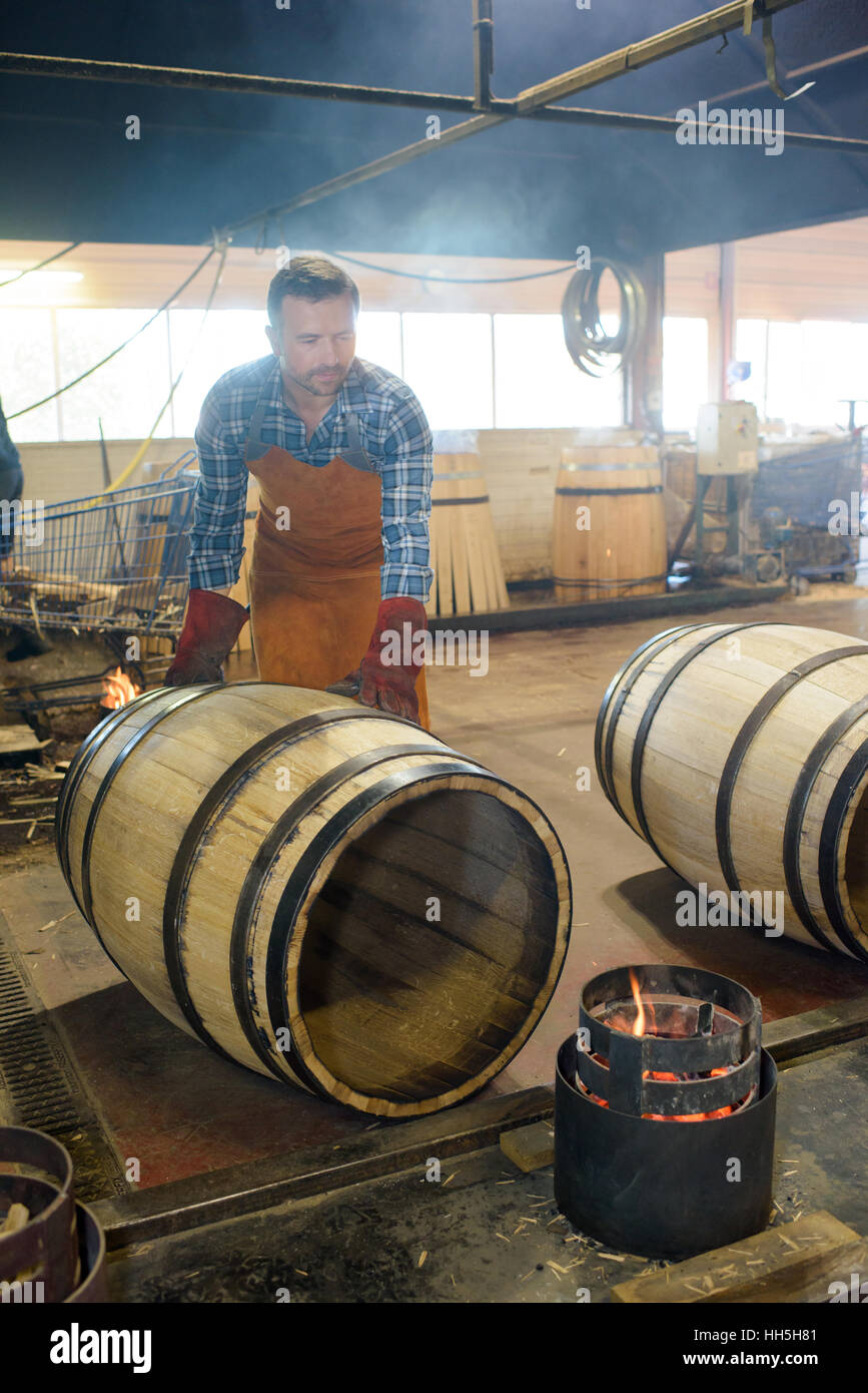 Cooper shaping barrel using heat Stock Photo - Alamy