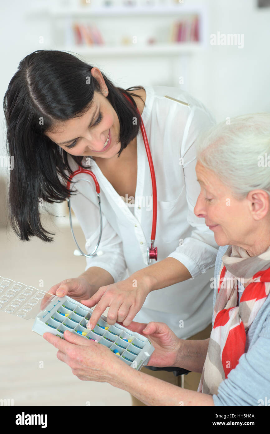 Carer explaining how medication is organised Stock Photo - Alamy