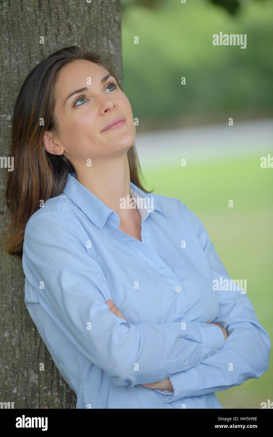 Lady leaning against tree hi-res stock photography and images - Alamy