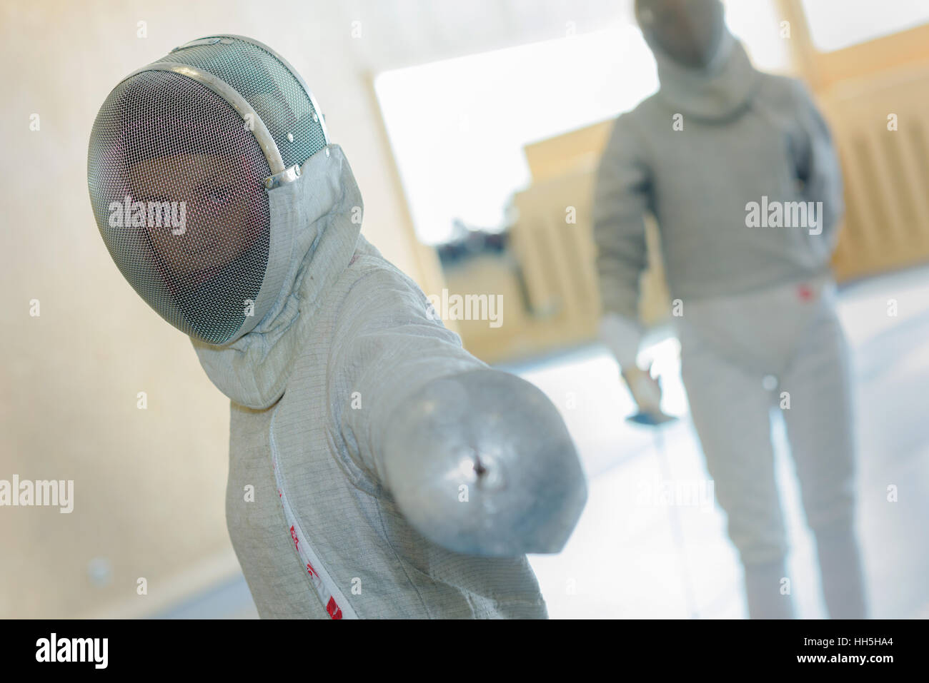 Woman in fencing posture Stock Photo - Alamy