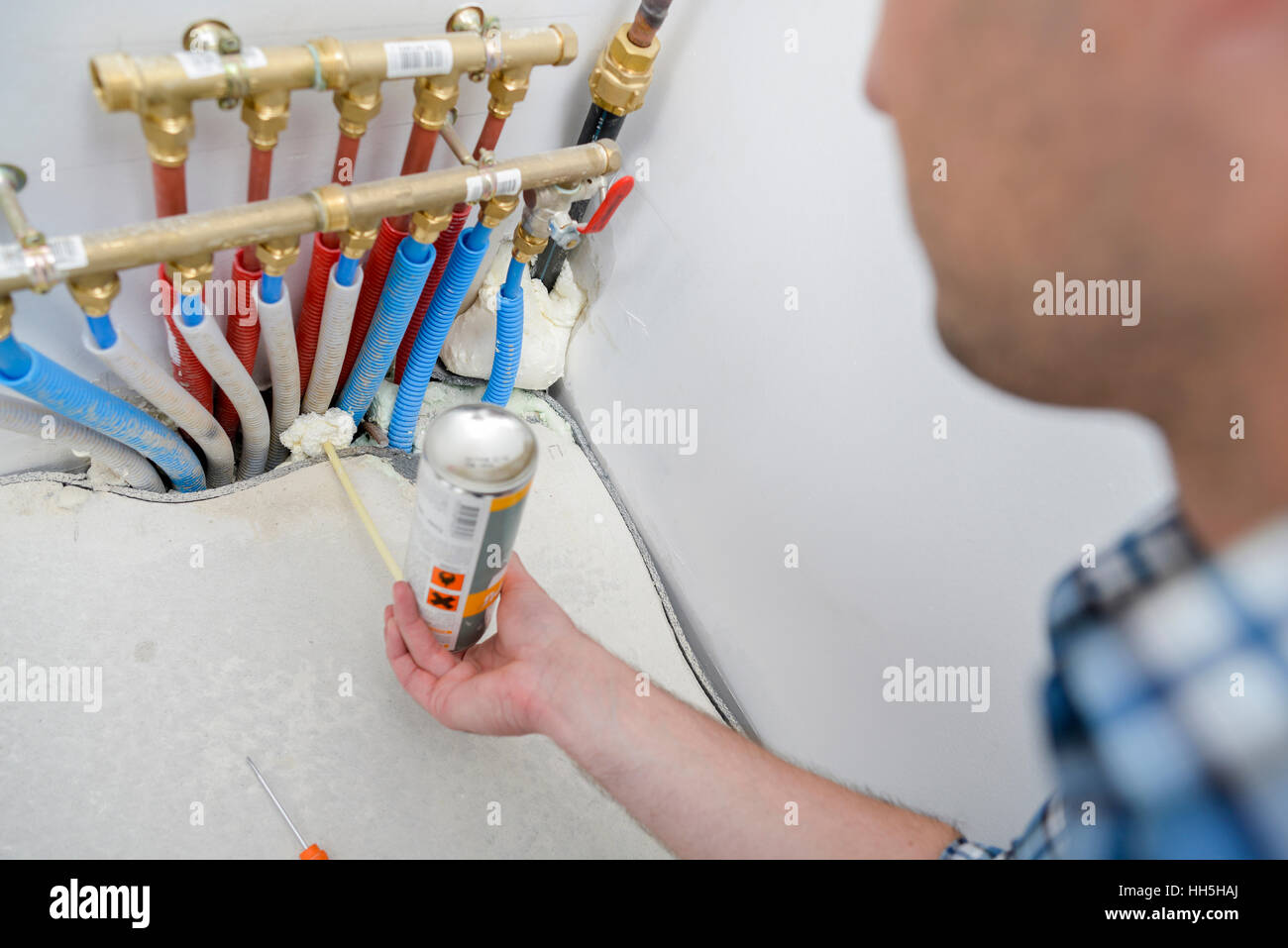 Plumber checking piping system Stock Photo - Alamy