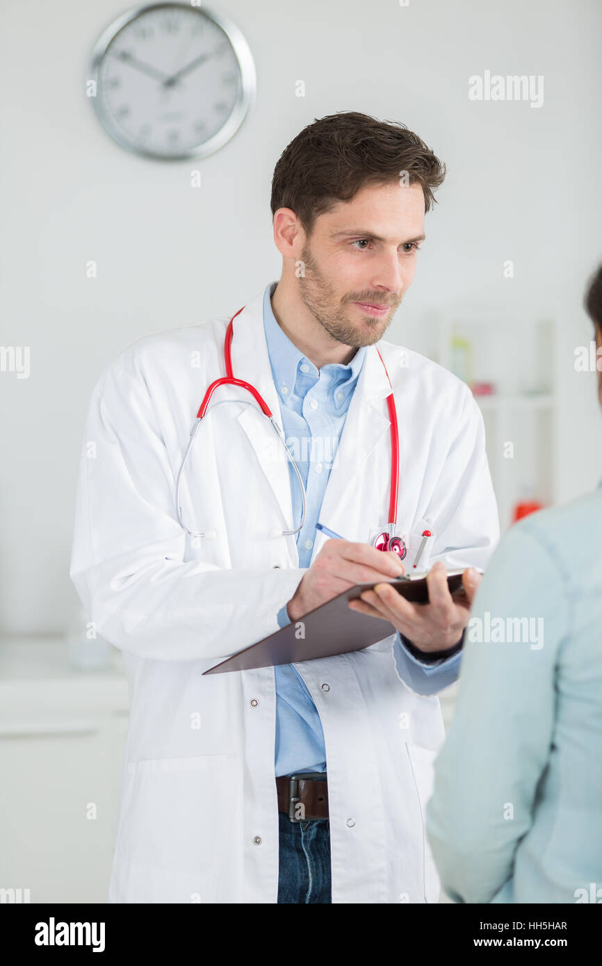 doctor taking notes to diagnose patient Stock Photo - Alamy