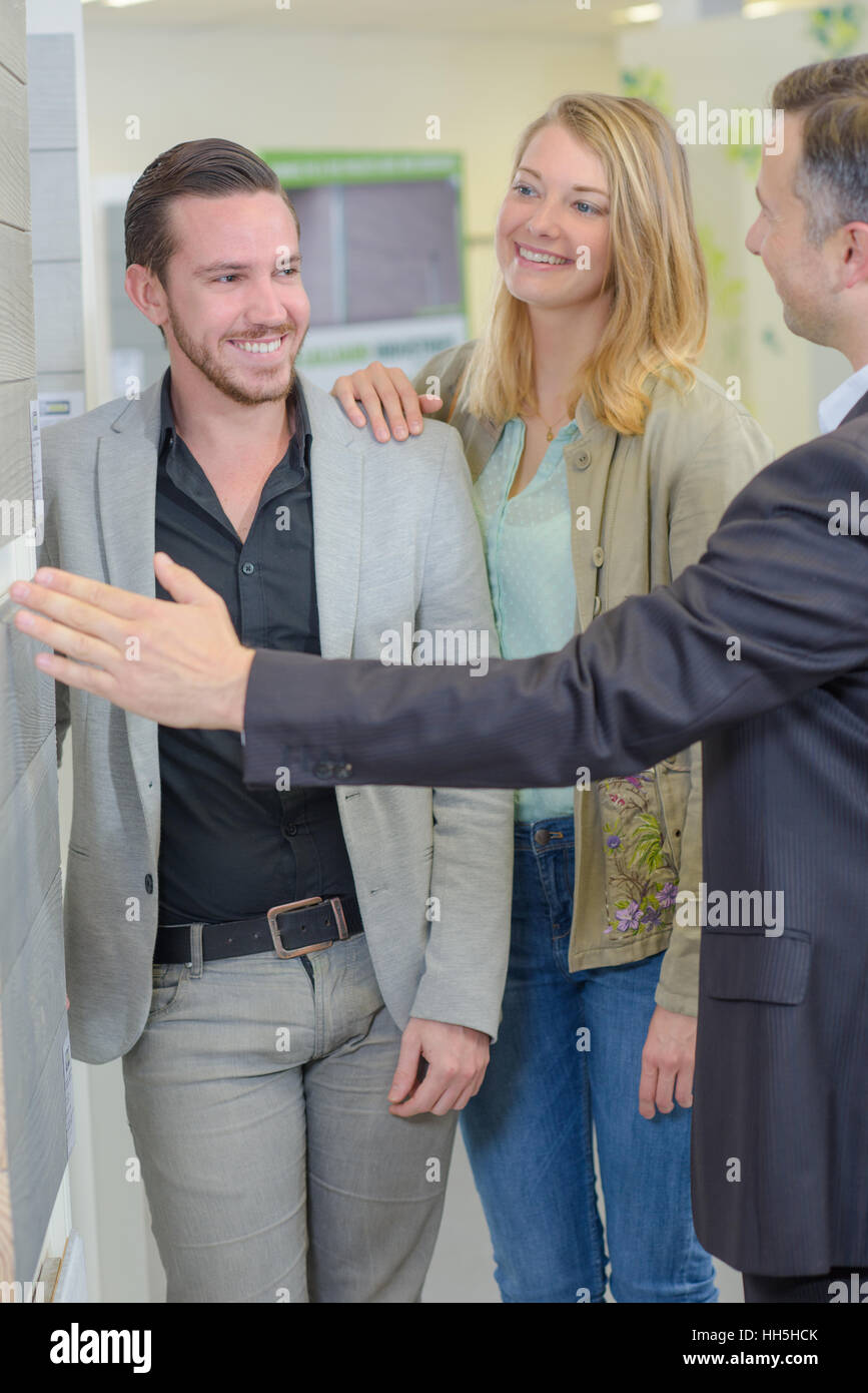 Sales rep with couple Stock Photo - Alamy