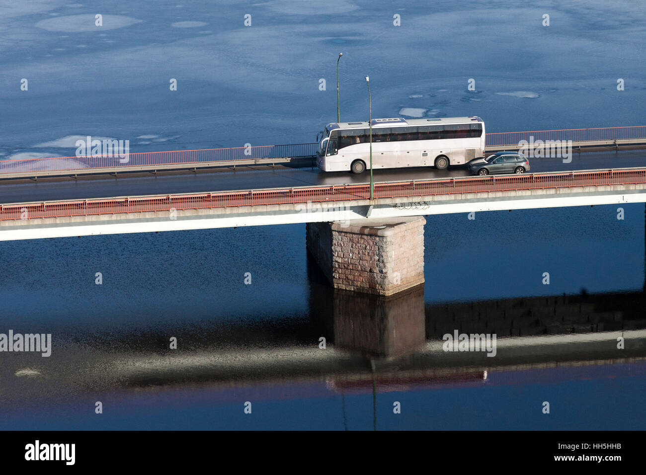 the tourist bus going on bridge through river in clear spring day Stock ...
