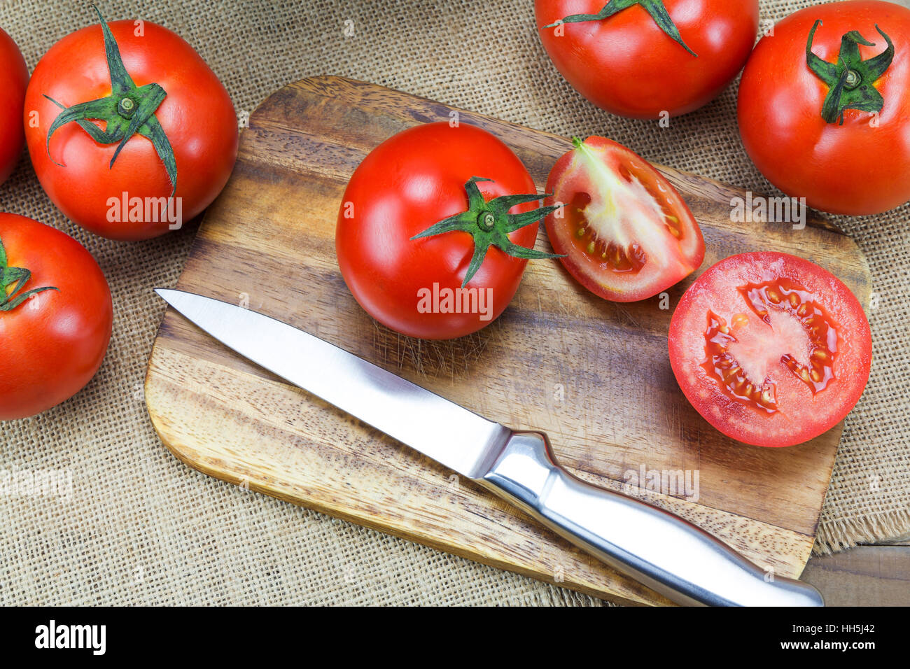 Closeup Fresh ripe tomatoes on wood background Stock Photo - Alamy