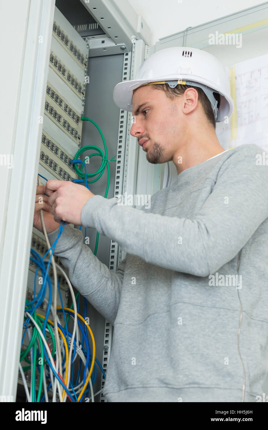 portrait of young electrician wiring an electric panel Stock Photo - Alamy
